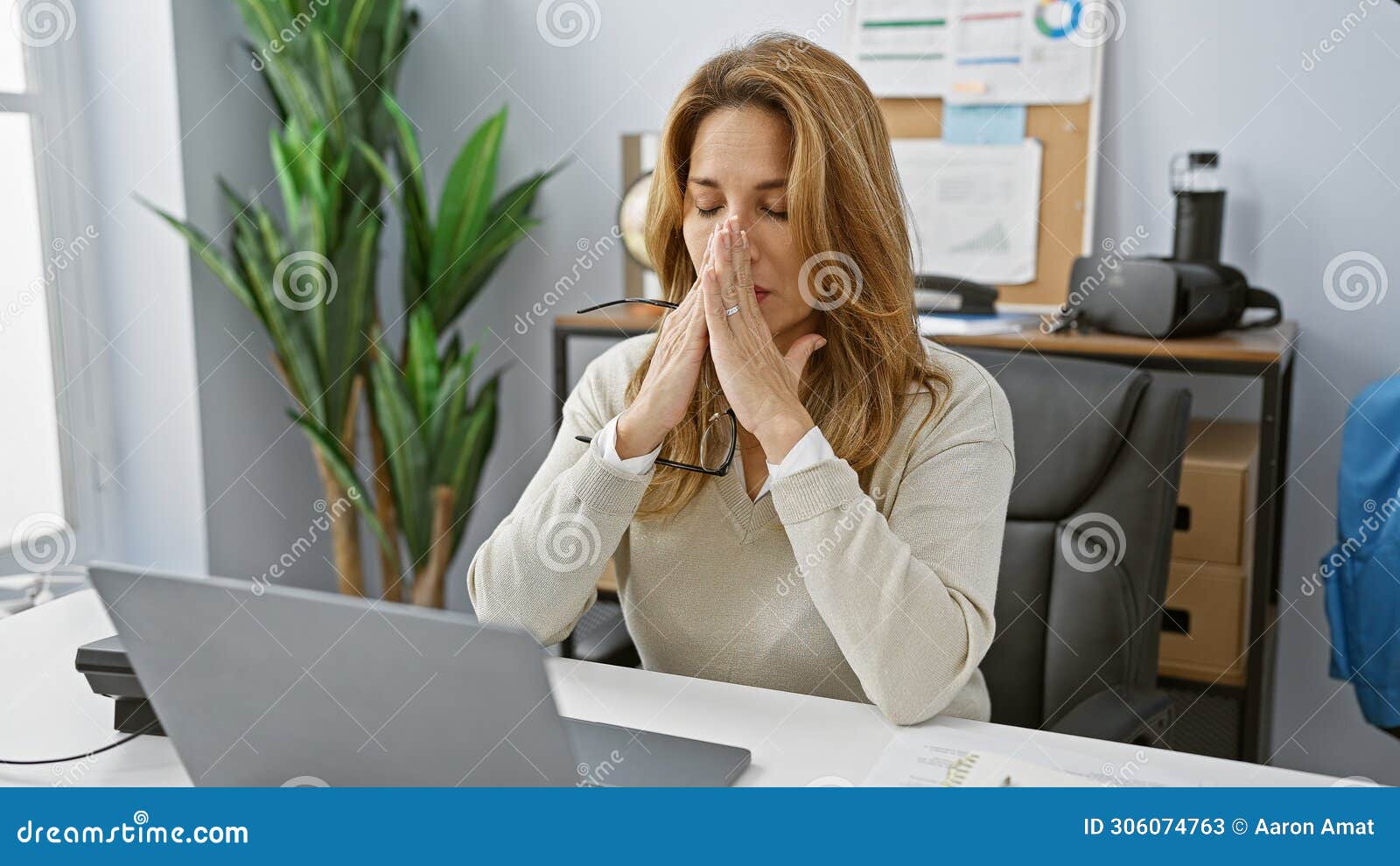 Stressed Woman in Office with Palms Pressed Together Looking for Solace ...