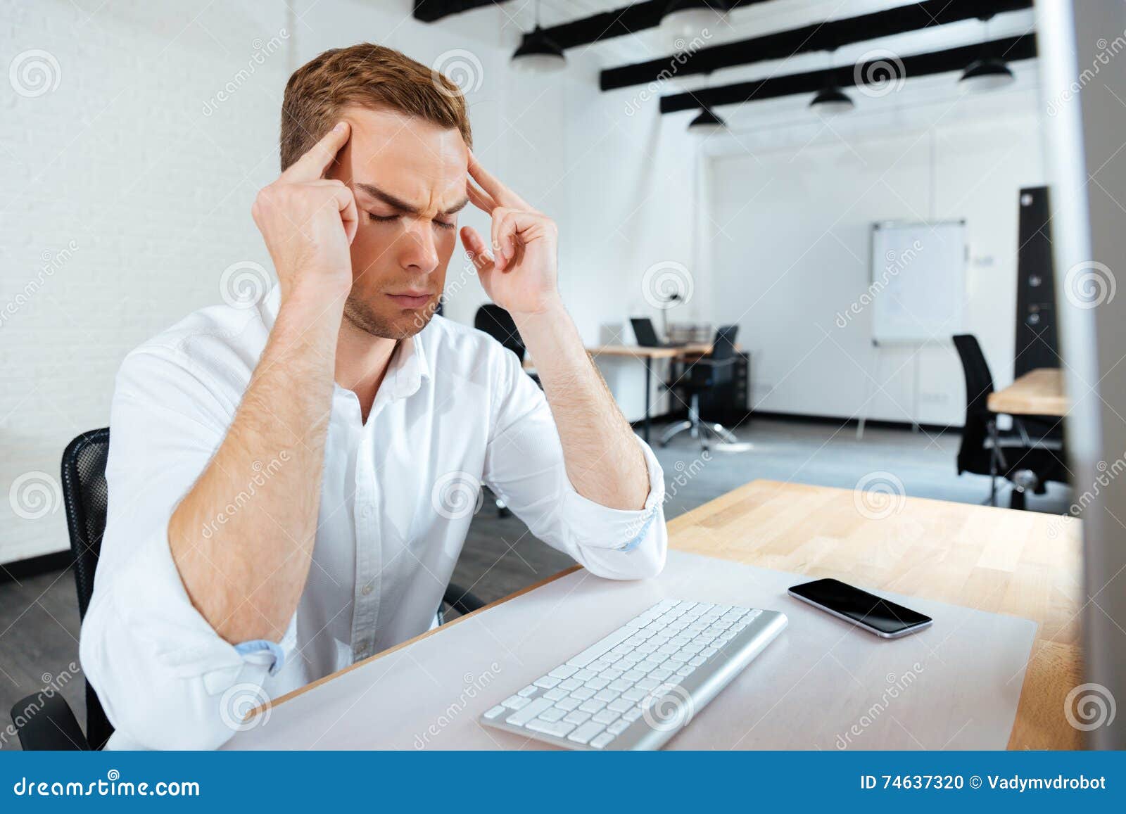 Stressed Young Businessman Having a Headache in Office Stock Photo ...