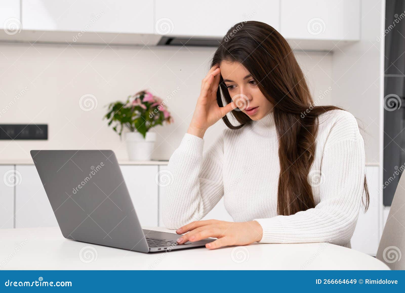 Stressed Young Woman Thinks Intensively while Working at a Computer at ...