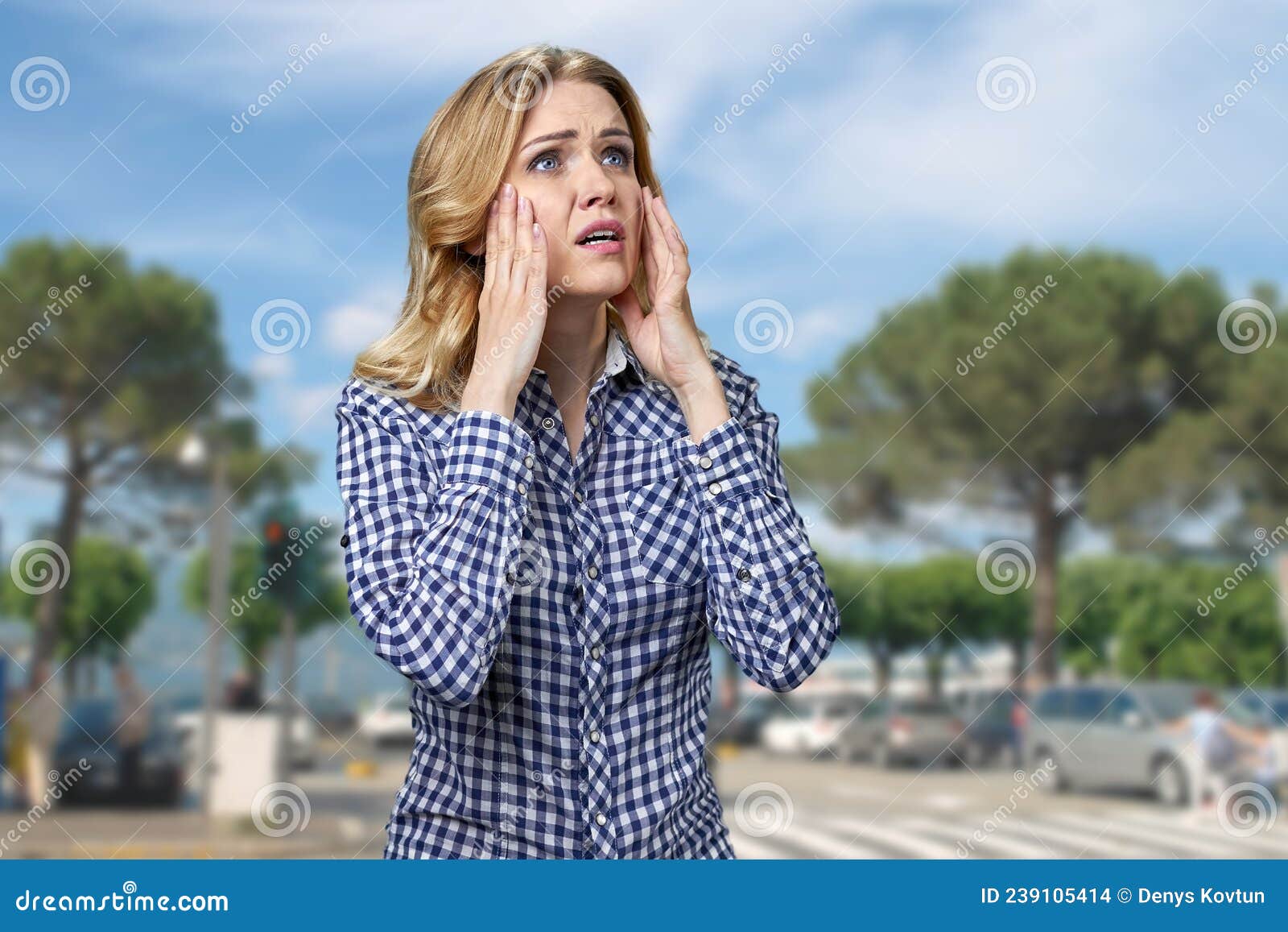 Stressed Young Woman Touching Her Face while Standing Outdoors. Stock ...