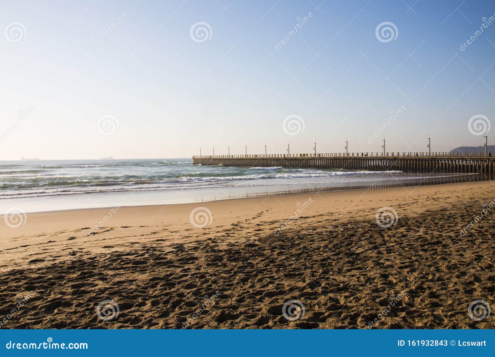 Stretch of Beach Divided by Pier Stock Image - Image of concrete ...