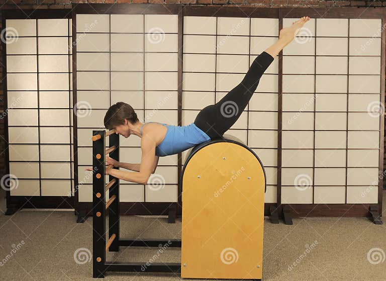 Stretch on Pilates Barrel stock photo. Image of muscular - 15201844