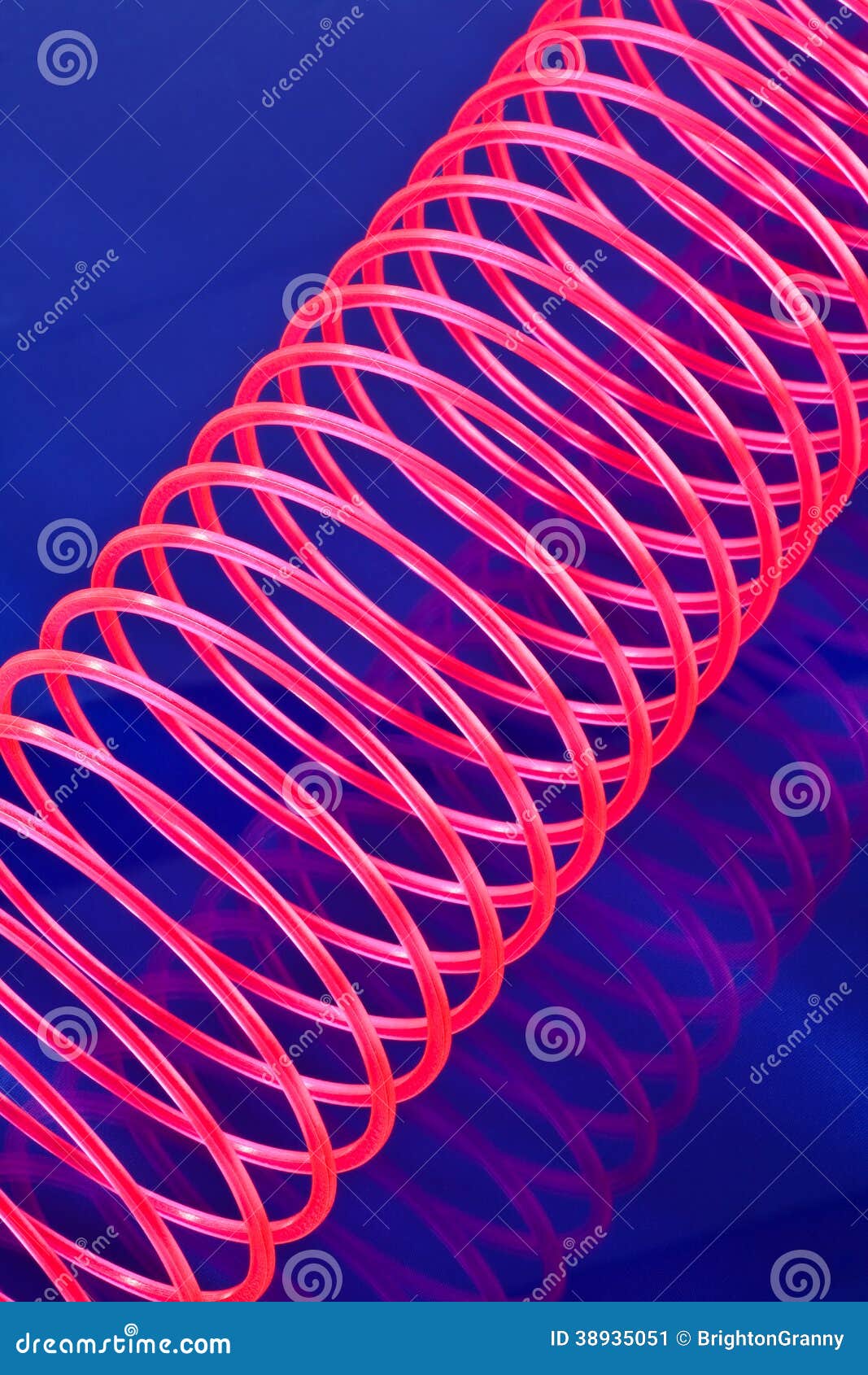 Stretched slinky editorial photo. Image of blue, color - 38935051