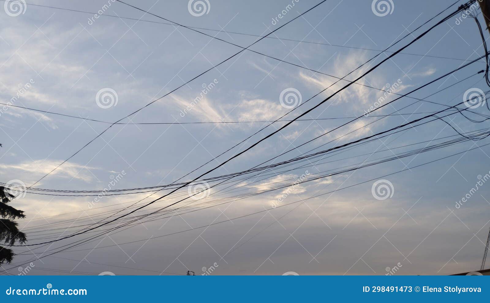 Stretched Wires Against a Background of Light Blue Sky and White Clouds ...
