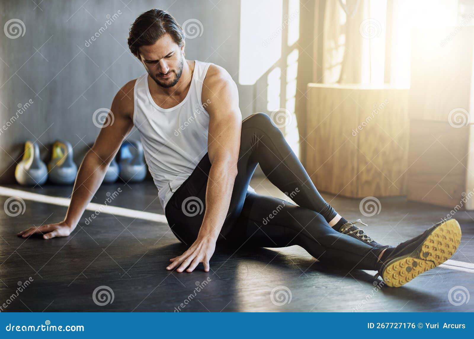 He Stretches before Every Workout. a Handsome Young Man Warming Up ...
