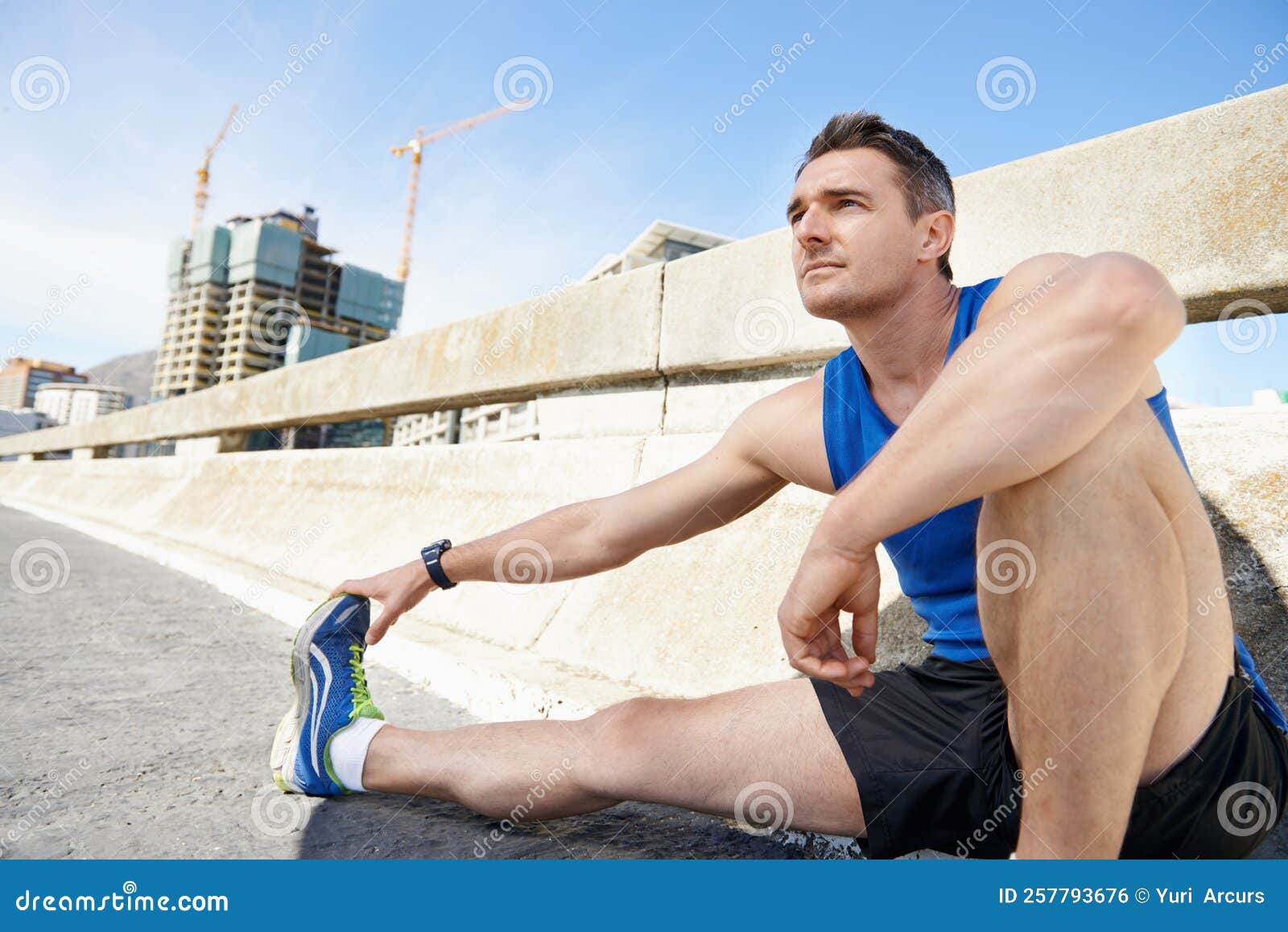 Stretching the Hamstrings. a Handsome Man Stretching His Hamstrings ...