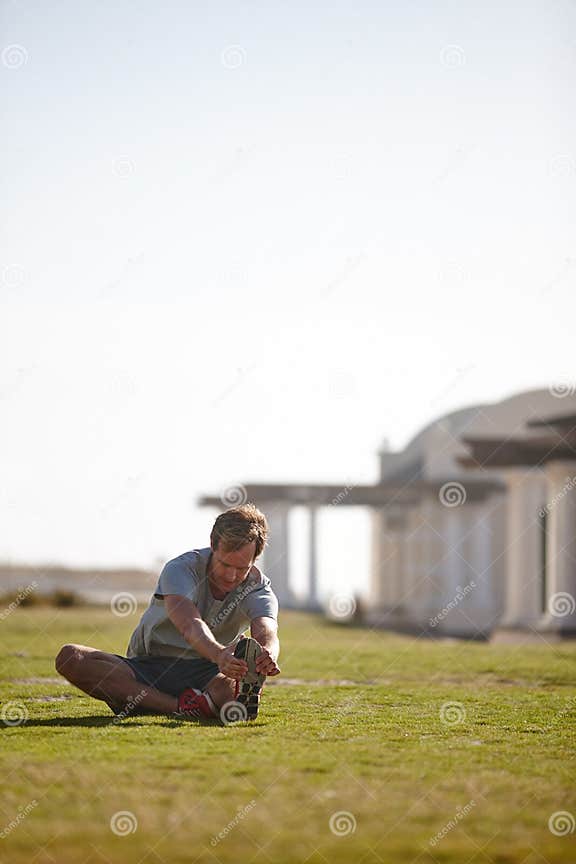 Stretching His Hamstrings. a Man Doing Stretches before His Workout ...