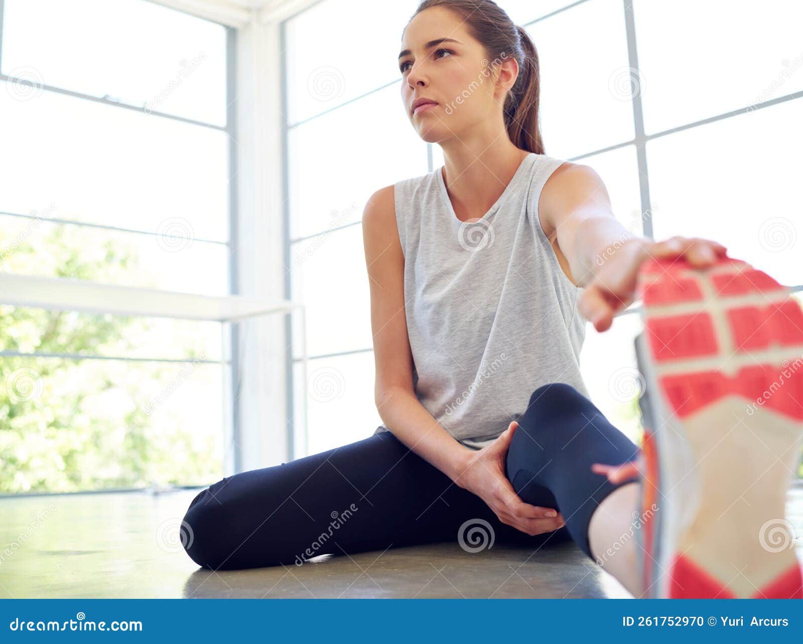 Stretching it Out. an Attractive Young Woman Stretching before a ...