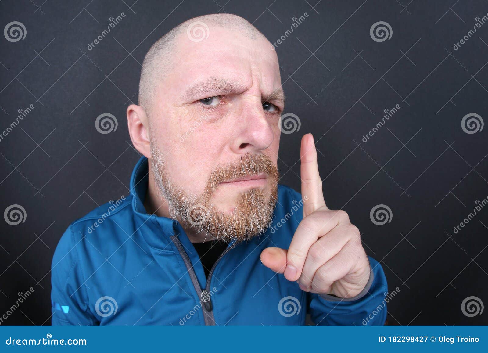 Strict Bearded Man With A Pointing Finger On Gray Background Stock ...