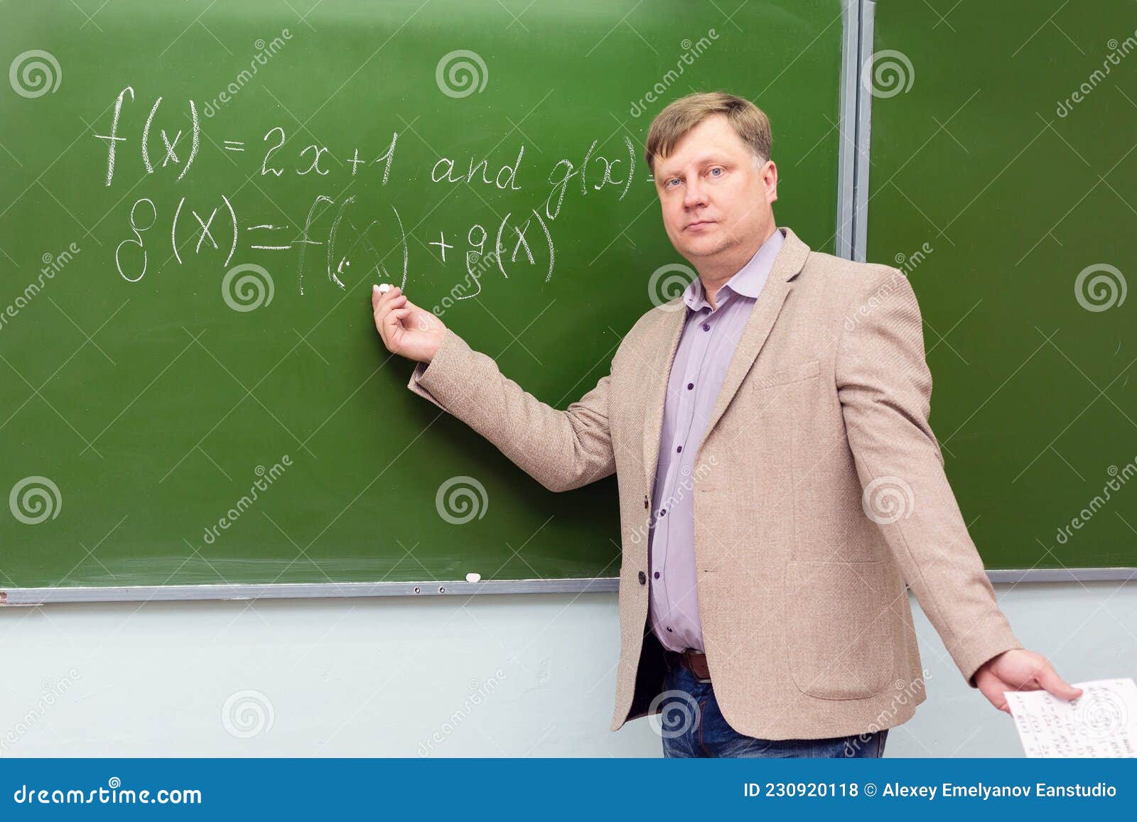 A Strict Math Teacher at the Blackboard Explains Stock Photo - Image of ...