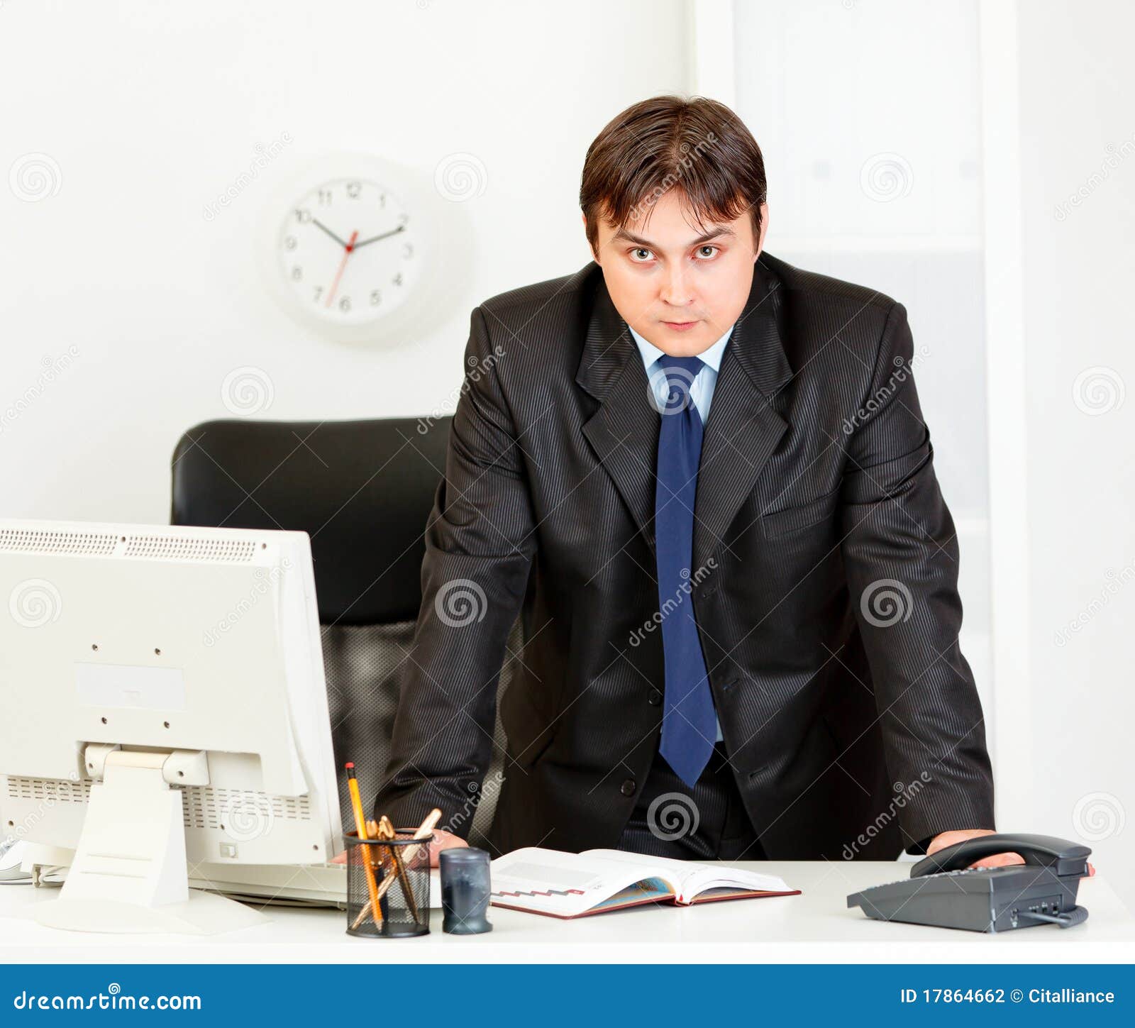 Strict Modern Businessman Standing at Office Desk Stock Photo - Image ...