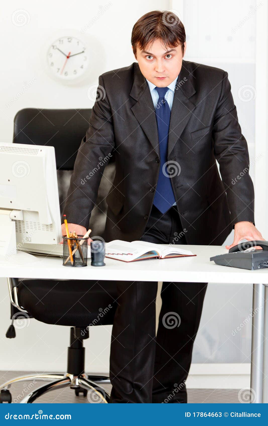 Strict Modern Businessman Standing at Office Desk Stock Image - Image ...