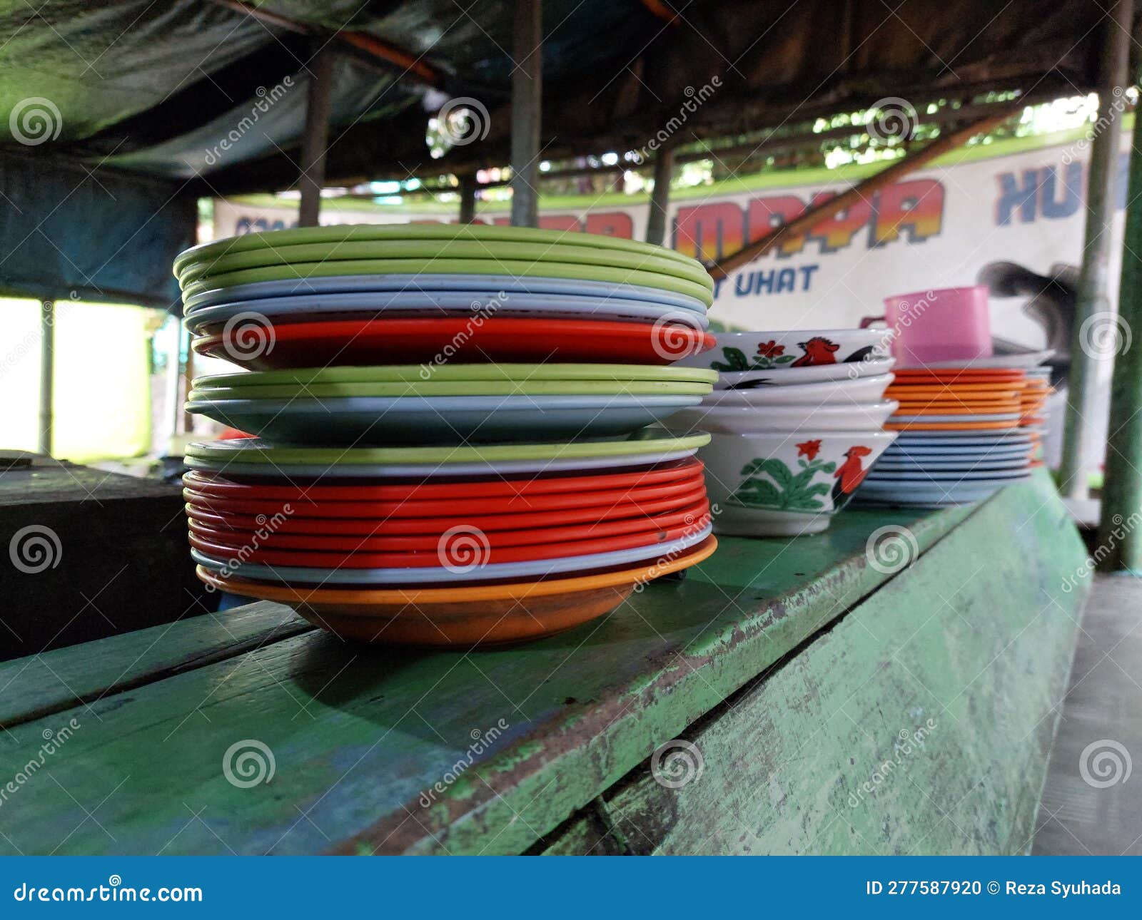 The Strict Pile of Color Plates Lies on a Table in Food Stalls Stock ...