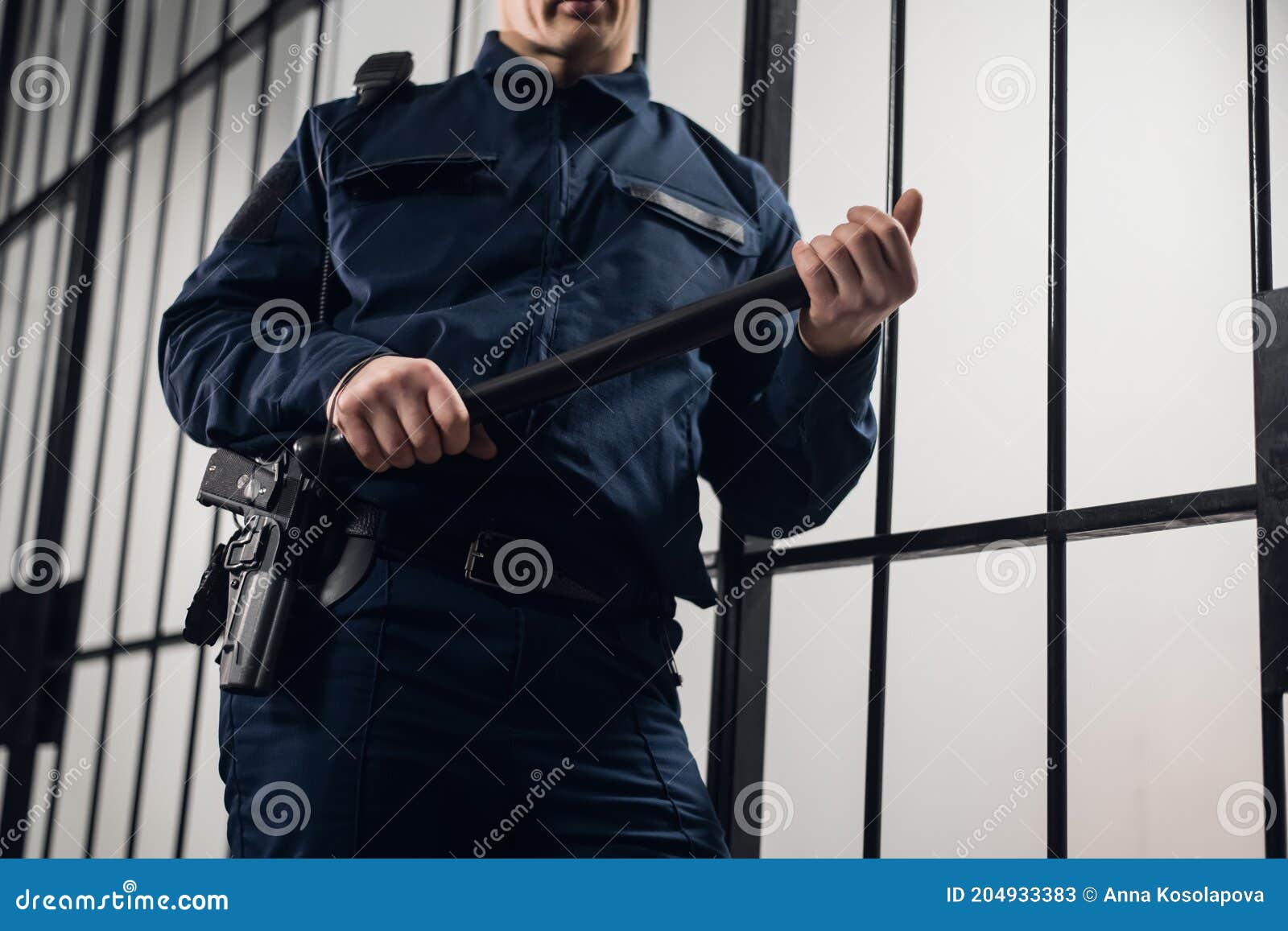 A Strict Prison Guard in Uniform Guards Cells with Prisoners in a ...