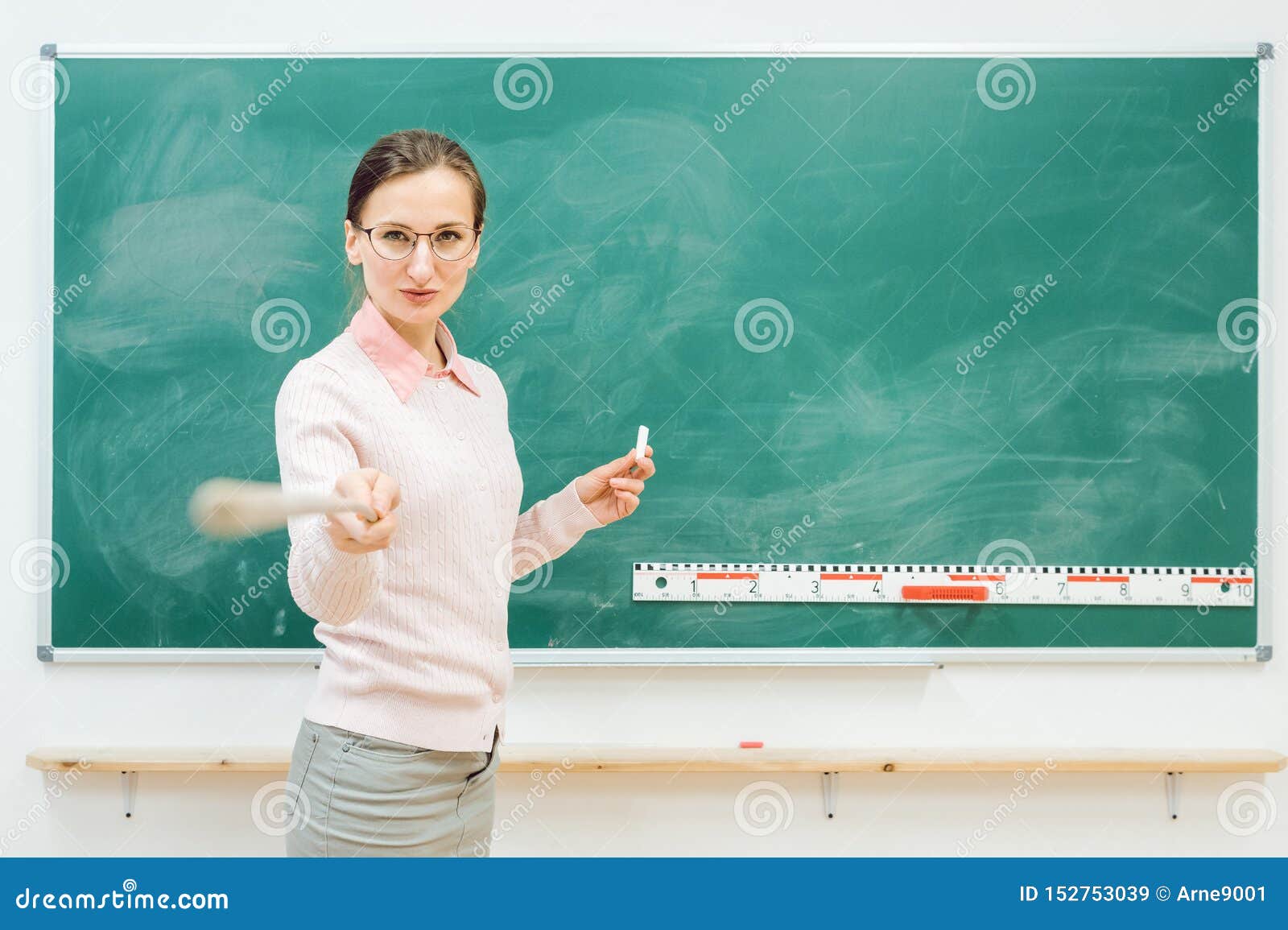 Strict Teacher Pointing with Pointer in Front of Blackboard Stock Image ...