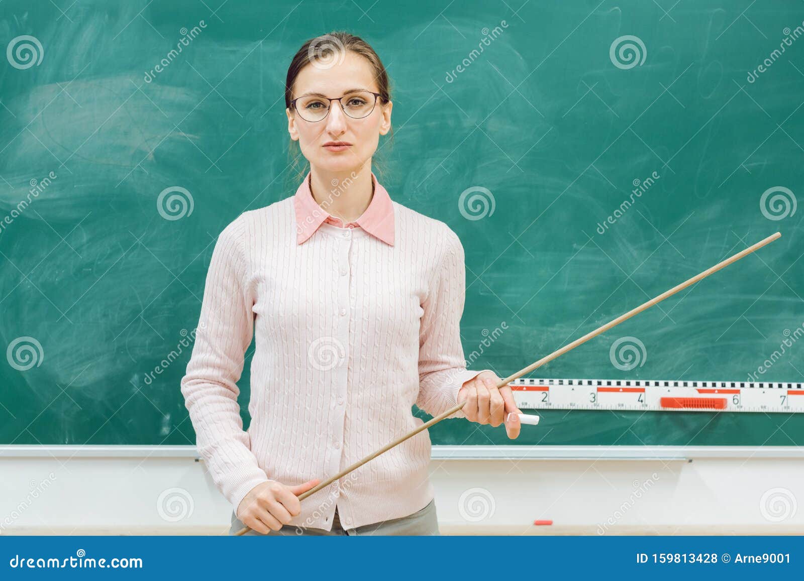 Strict Teacher In Glasses Giving Explanations While Holding Book. Tutor ...