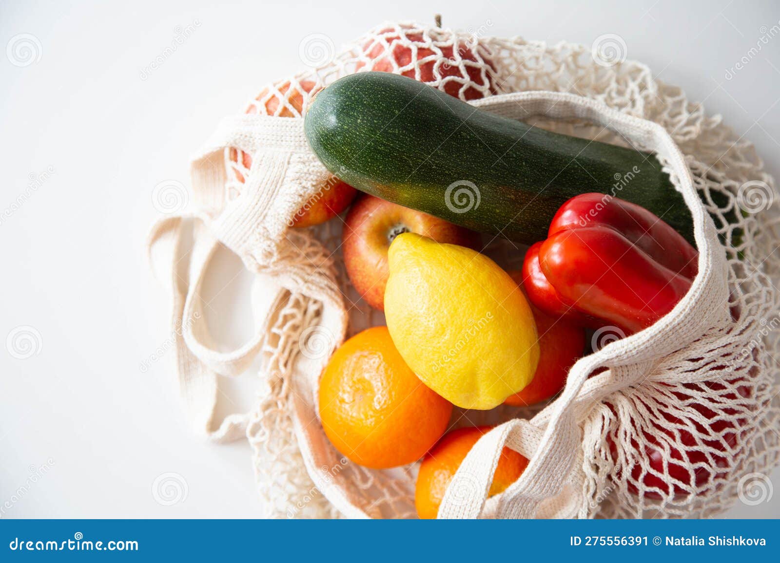 The String Bag of Natural Material with Fruits and Vegetables is on a ...
