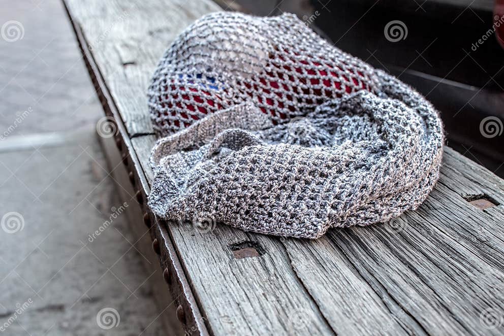 String Bag with Various Knitting Yarn on Old Wood Bench Stock Photo ...
