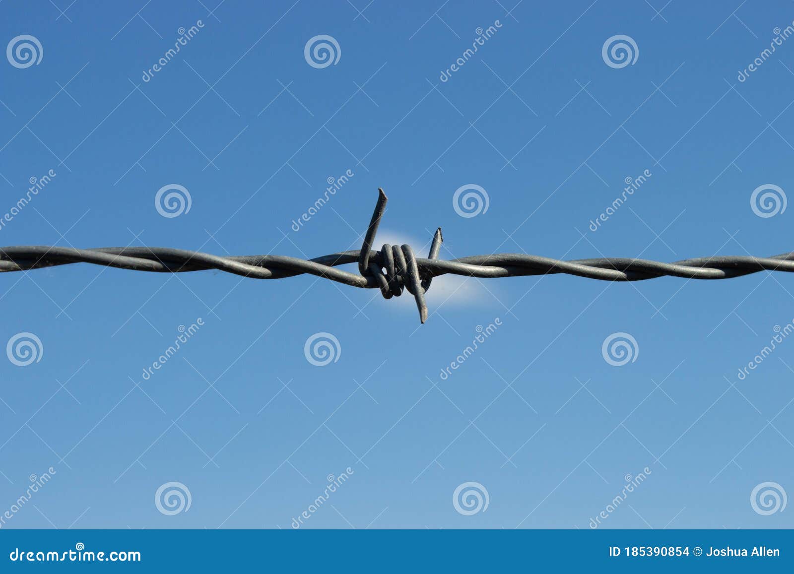 A String of Barbed Wire with a Cloud Behind Stock Photo - Image of ...