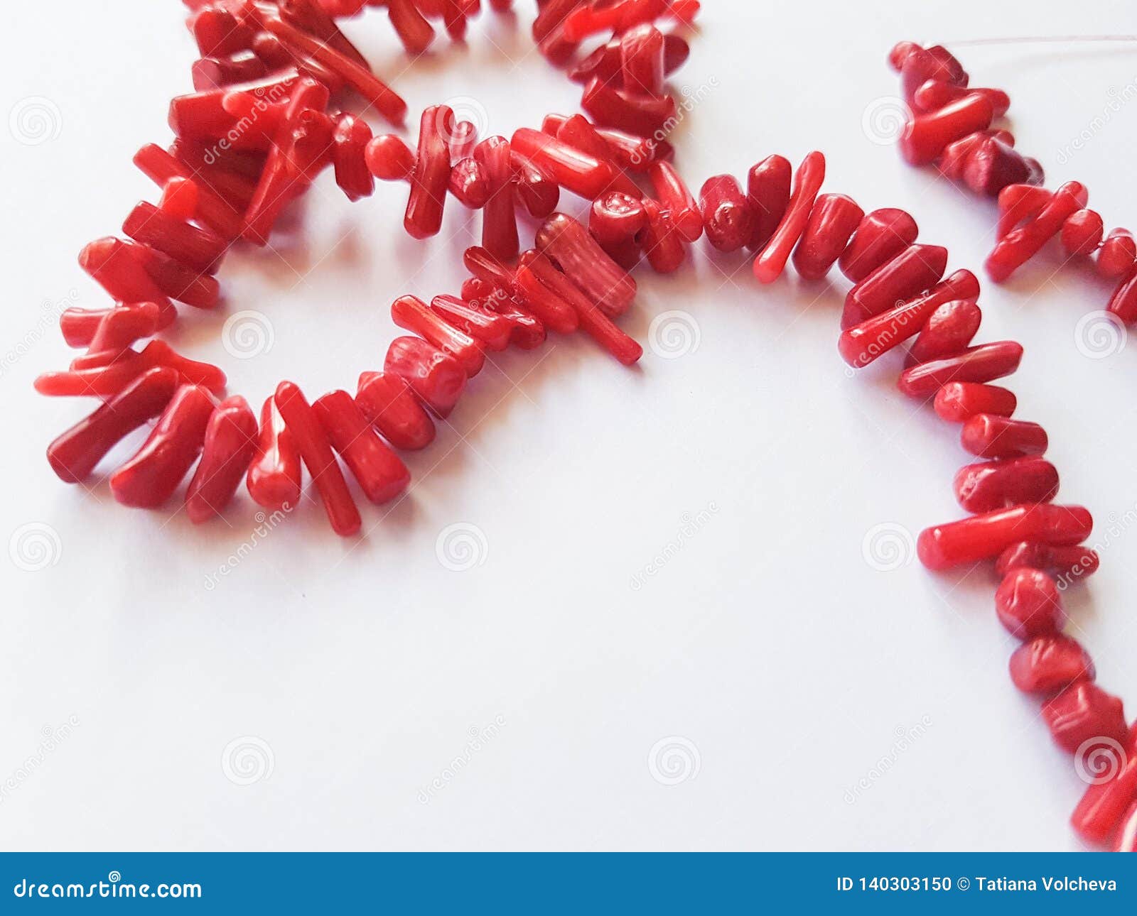 A String of Beads from Pieces of Coral on a White Background Stock ...