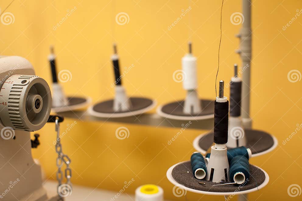 String of Black and White Threads on White Sewing Machine on Yellow ...