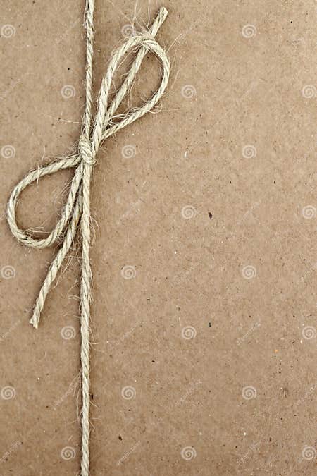 String Bow on Brown Paper stock photo. Image of recycled - 22999590