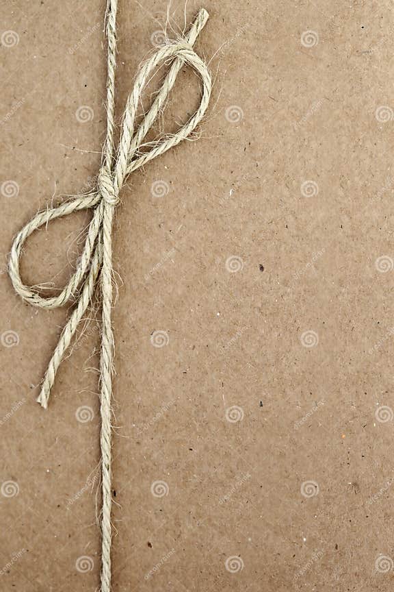 String Bow on Brown Paper stock photo. Image of recycled - 22999590