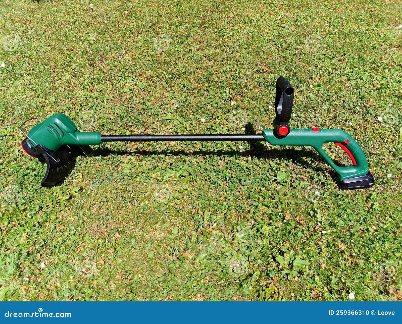 String Electric Lawnmower, Trimmer, Green Plastic Body, Placed on the ...