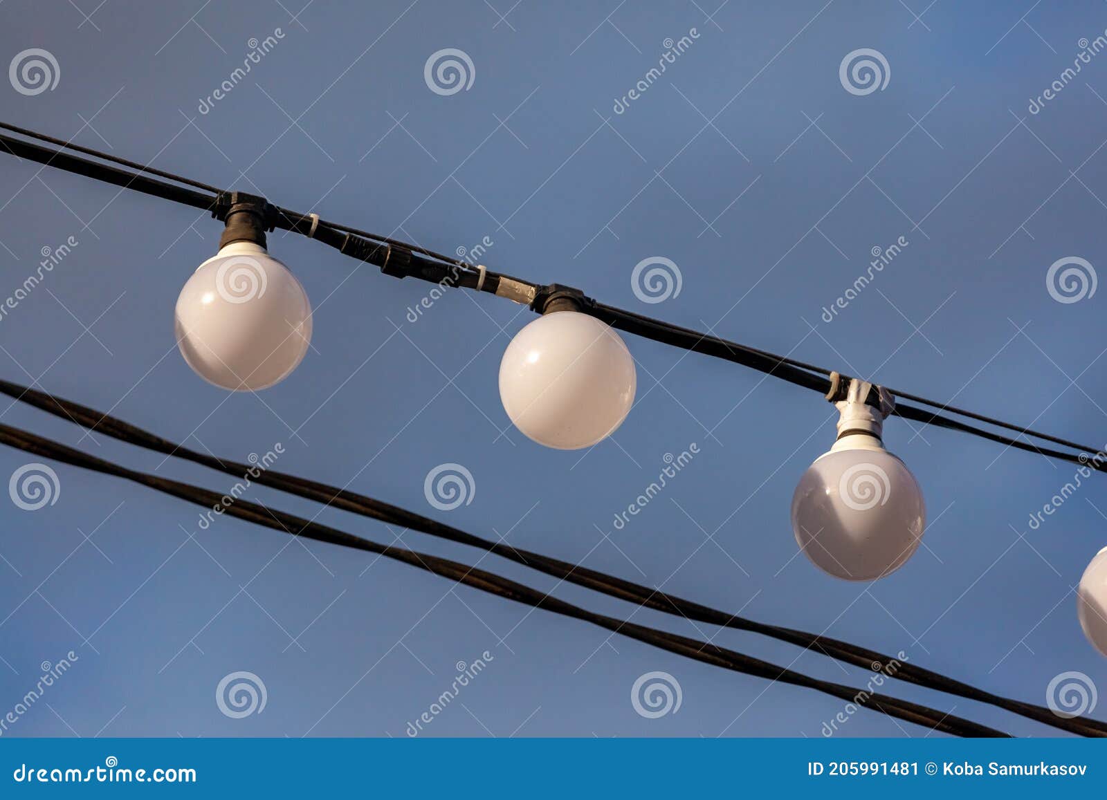 String Light Bulb on a Blue Sky Background Stock Image - Image of ...