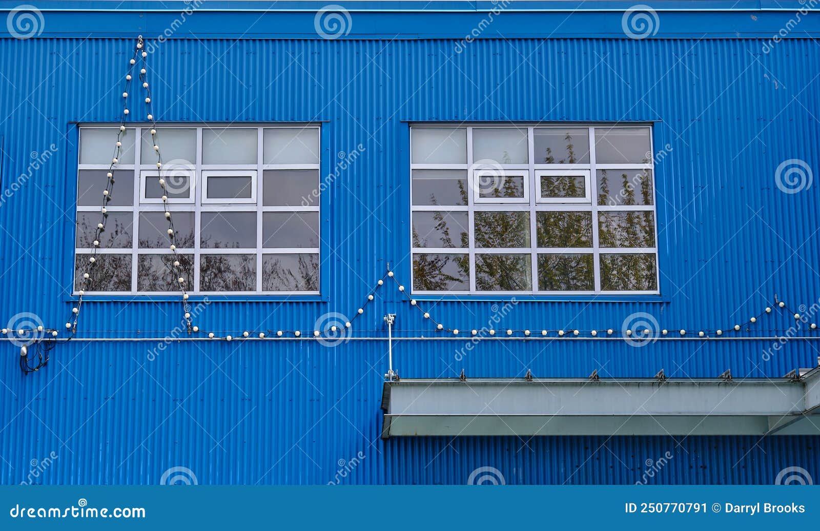 String of Lights on Blue Building Stock Image - Image of architectural ...