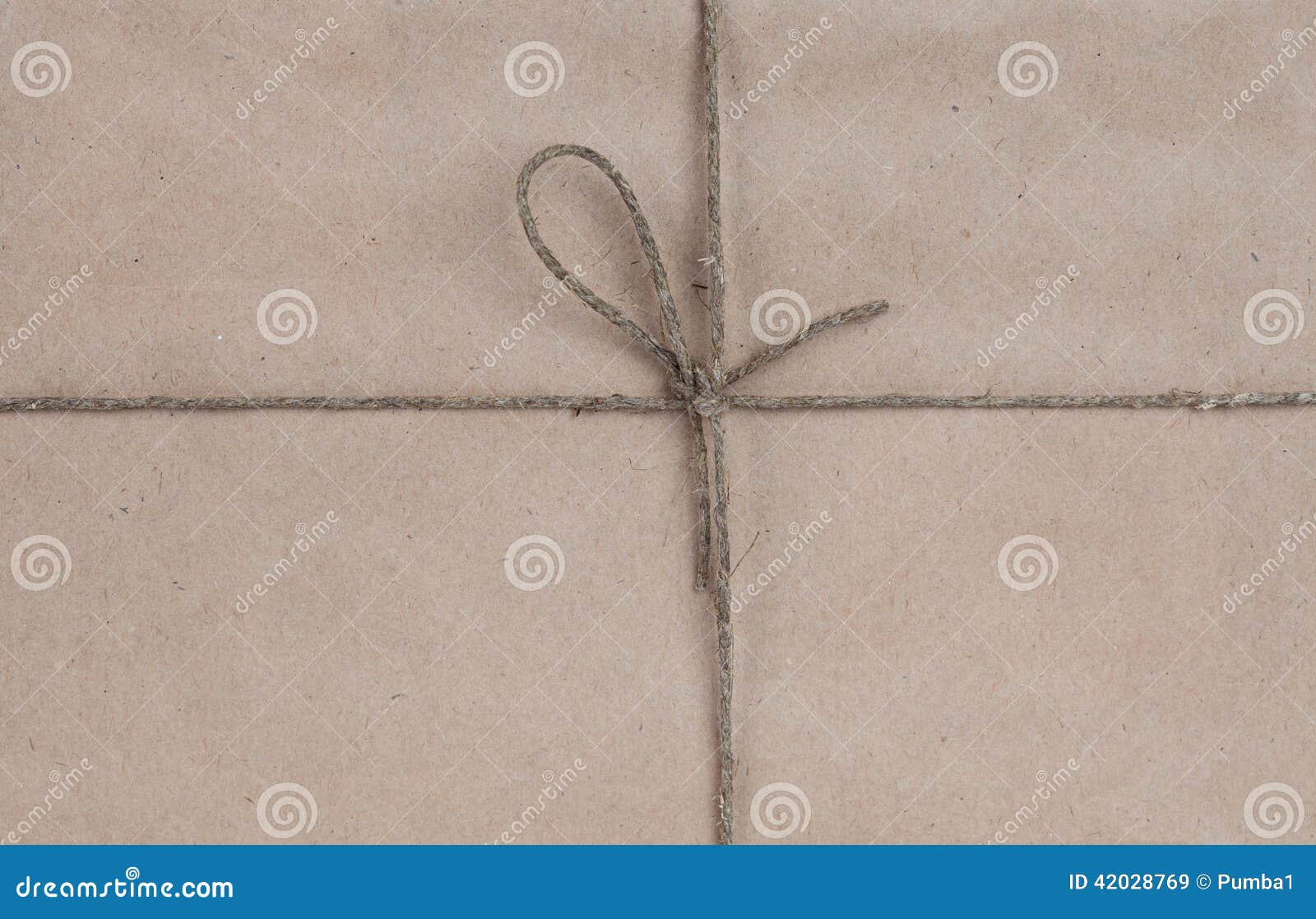 String Tied in a Bow on a Brown Recycled Paper Stock Image - Image of ...