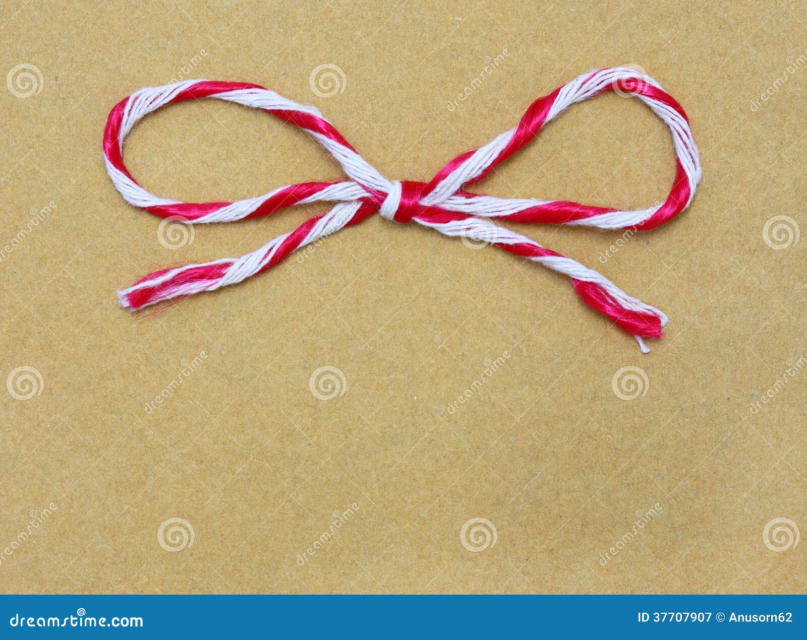 String Tied in a Bow, Over Brown Paper Stock Image - Image of recycled ...
