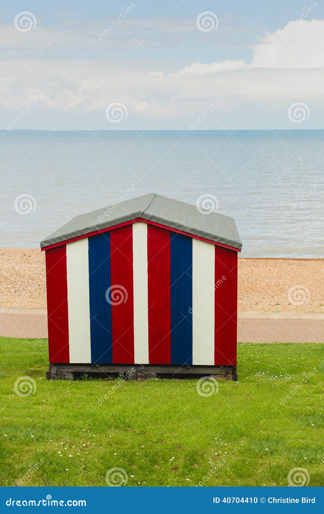 Striped Beach Hut on Grass, by the Sea Stock Photo - Image of ...