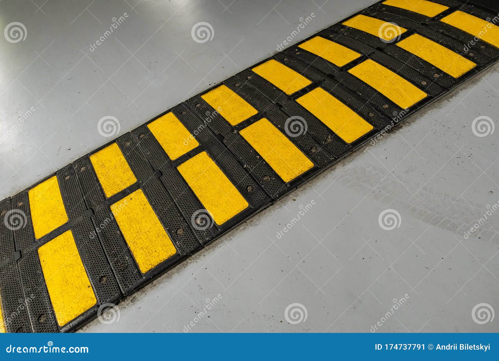 Striped Black and Yellow Speed Bump on a Road Stock Image - Image of ...