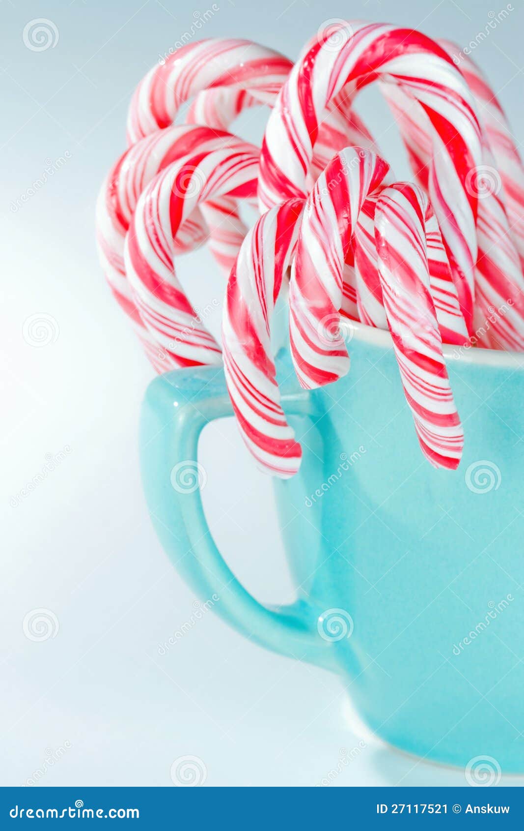 Striped Candy Canes in a Light Blue Cup Stock Image - Image of ...