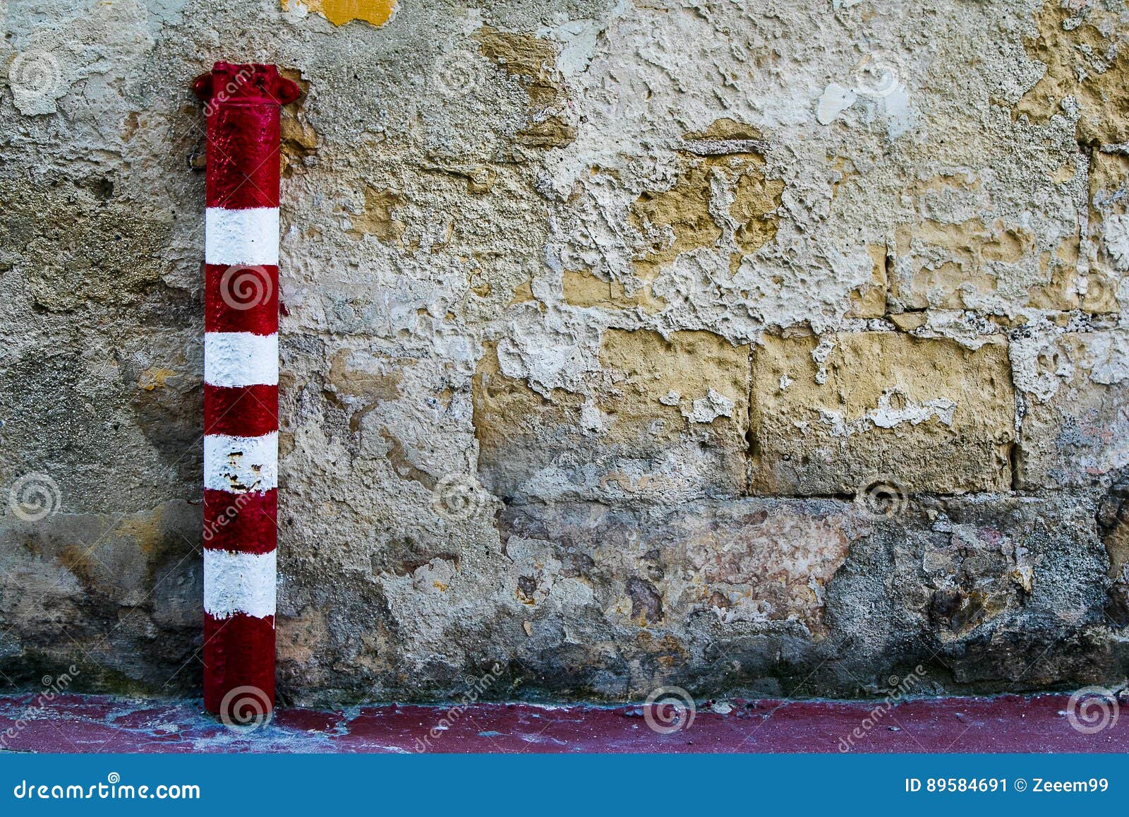 Striped Red and White Pole Against a Textured Wall Stock Image - Image ...