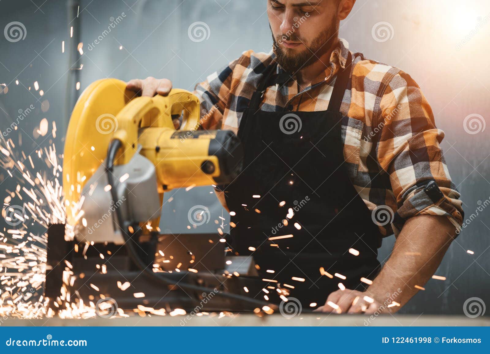 Strong Bearded Mechanic Working On Angular Grinding Machine In ...