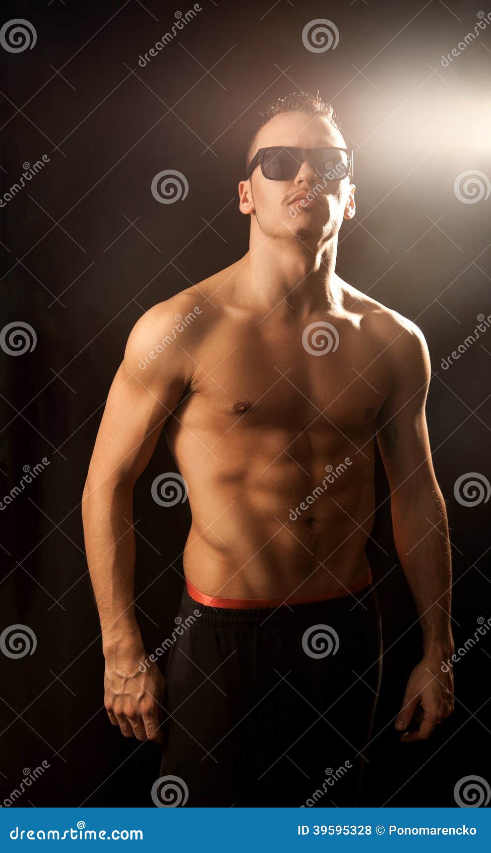 Strong Caucasian Mature Male Athlete Wearing White T-shirt And Wireless ...