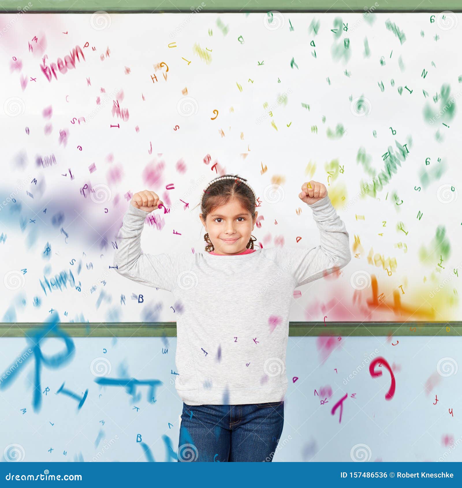 Strong Girl in Elementary School in Front of Blackboard Stock Photo ...