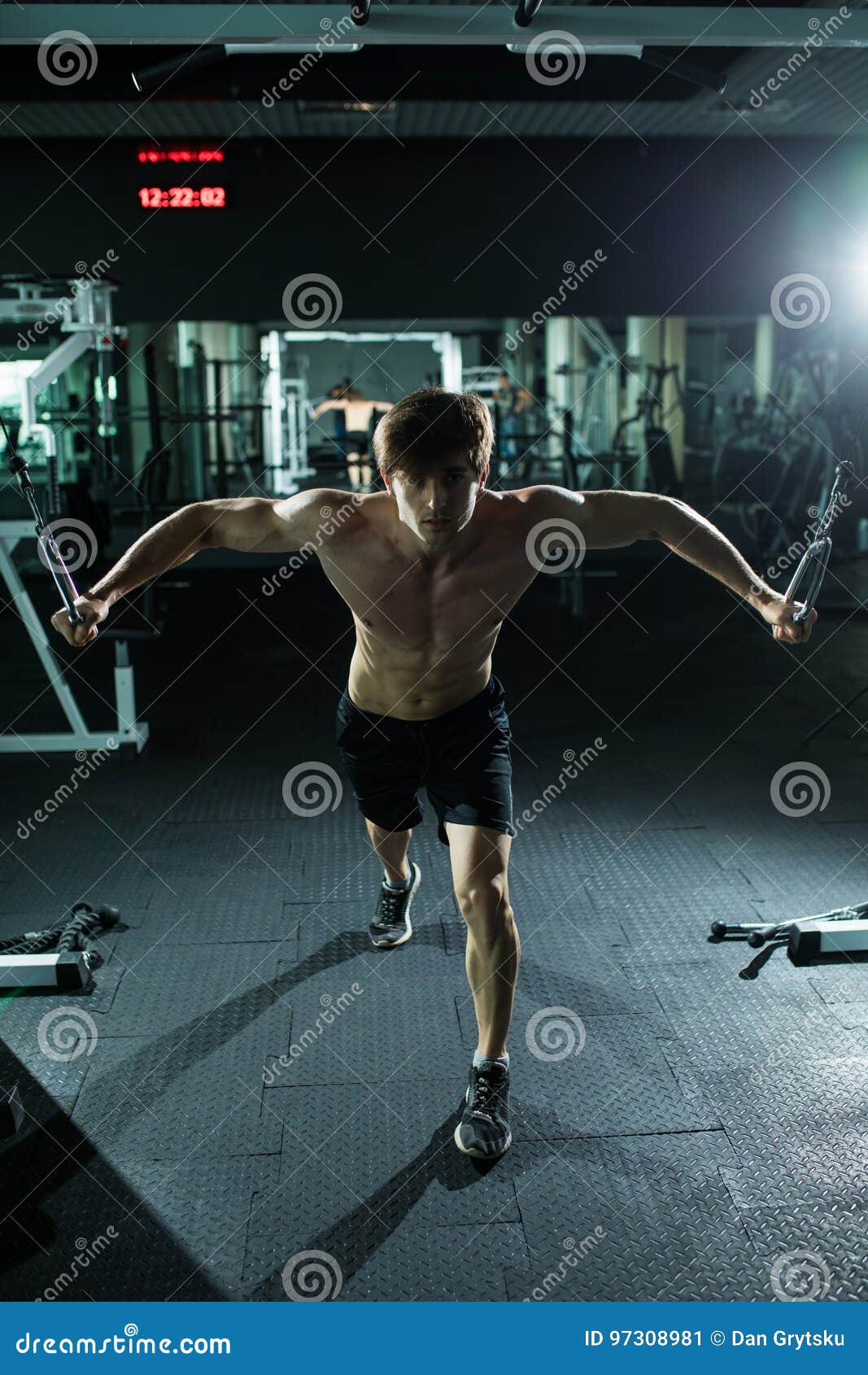 Strong Handsome Man Exercising at the Gym with Machine. Stock Image ...