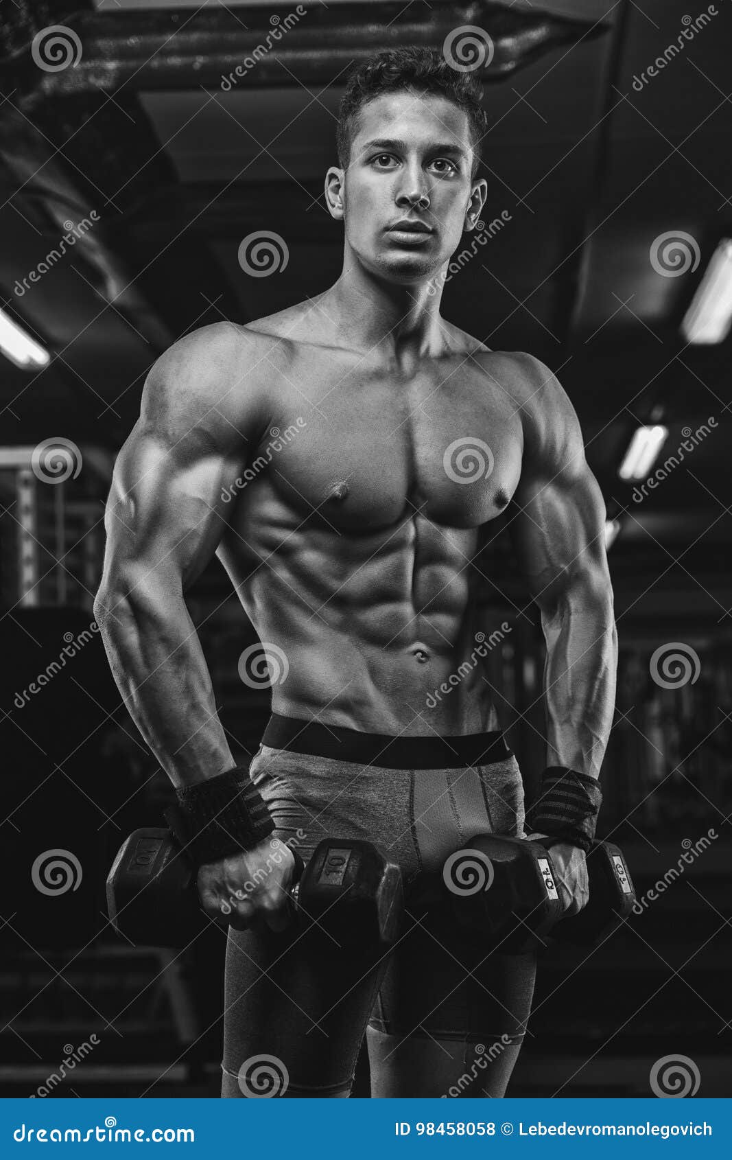Strong and Handsome Young Man Doing Exercise with Dumbbells Stock Photo ...