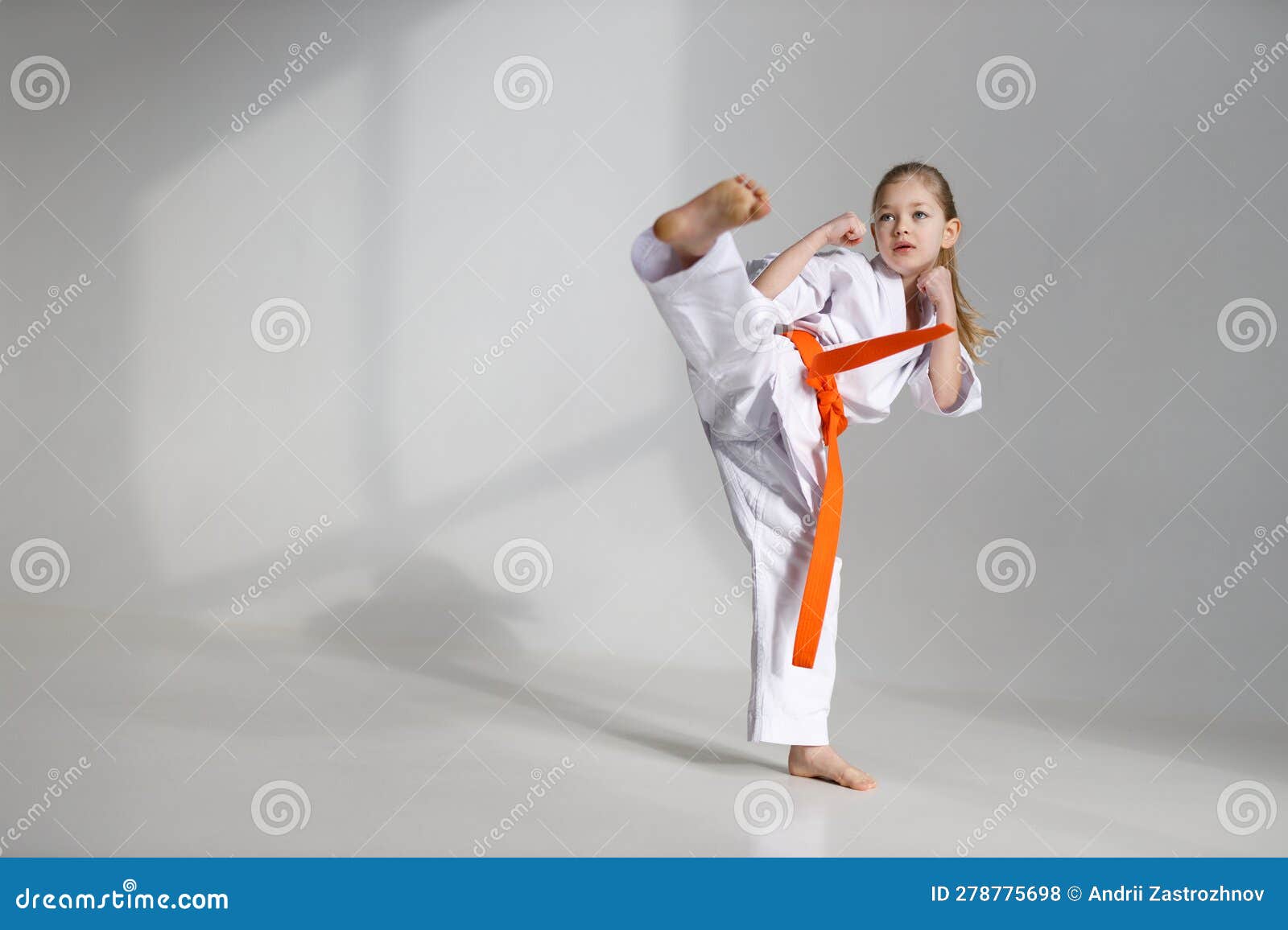 A Strong Kick by a Little Girl in a White Kimono Stock Photo - Image of ...