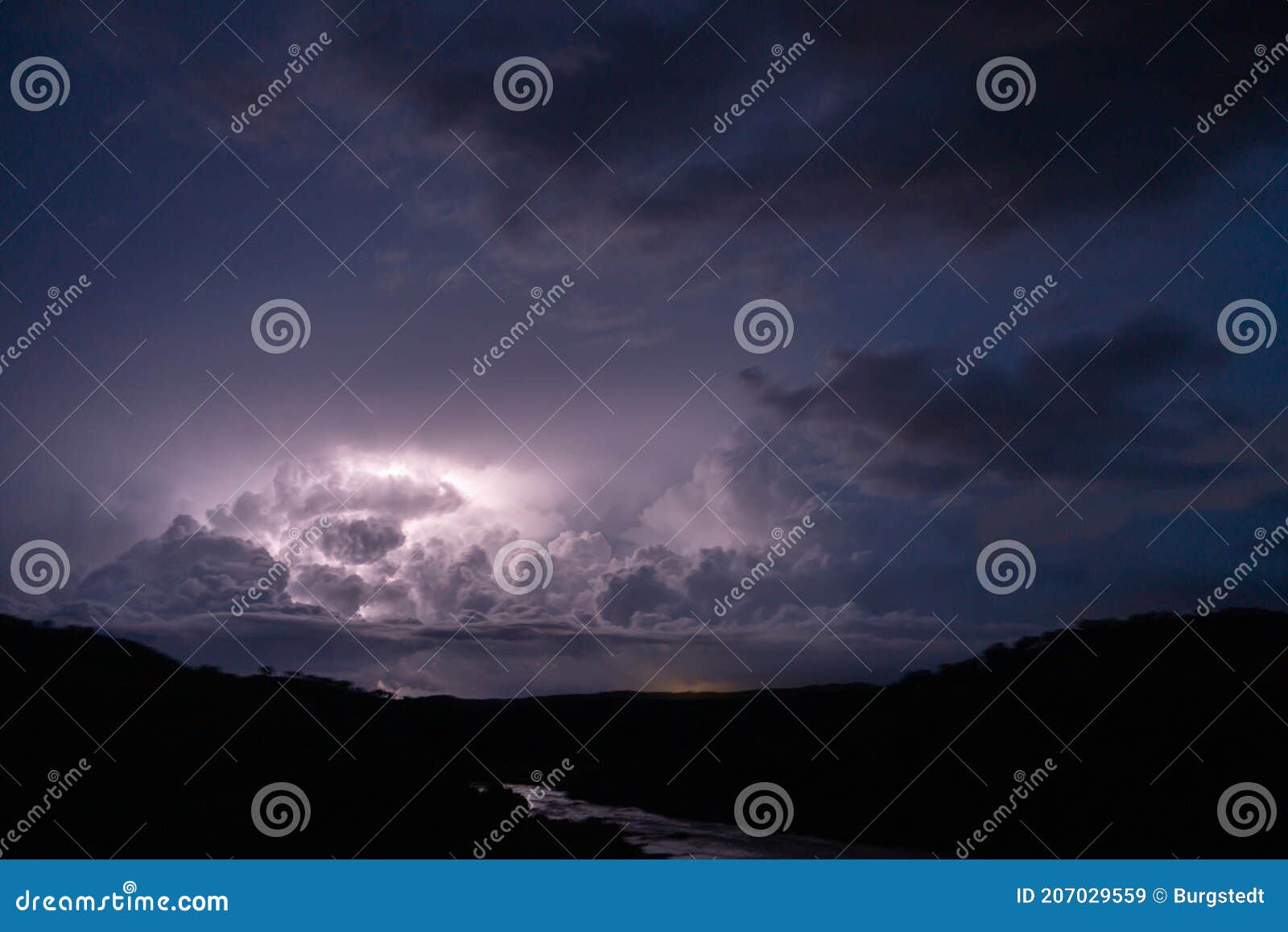 Strong Lightning in and Behind Big Towering Thunderclouds Stock Image ...