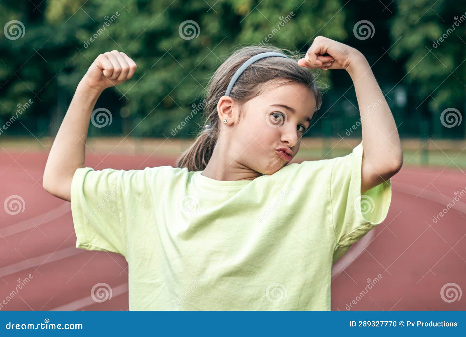 Strong Little Girl Posing Outdoors Showing Their Muscles. Stock Photo ...