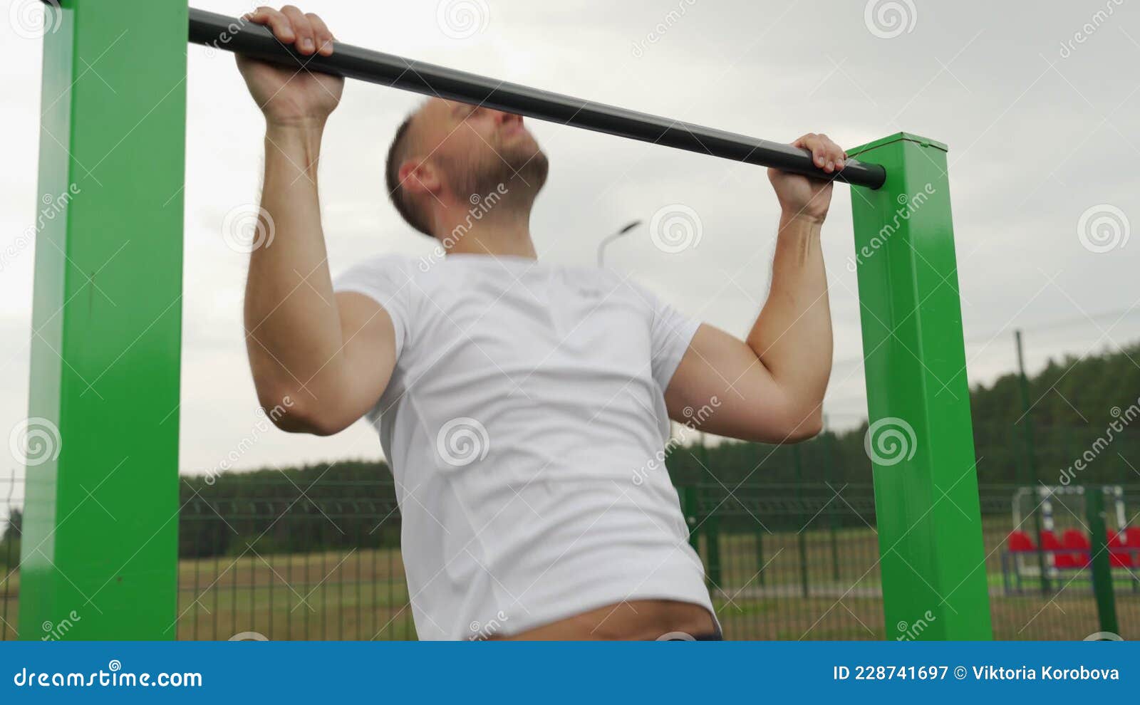 Strong Man from Behind Doing Pull Ups on Horizontal Bar. Mans Fitness ...