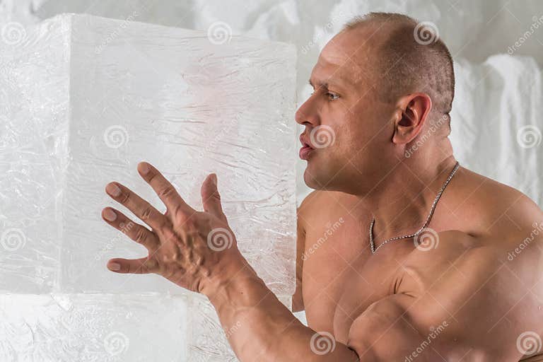 A Strong Man with Big Muscles Blowing on Ice Stock Image - Image of ...