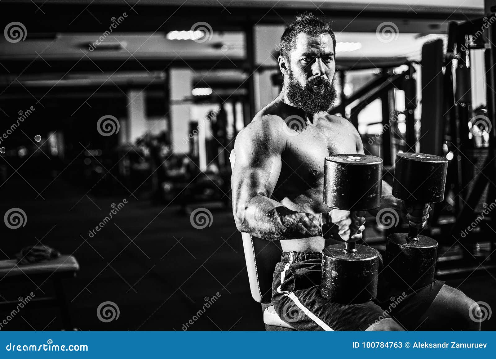 Strong Man with Big Muscles, Posing at the Camera in the Gym Stock ...