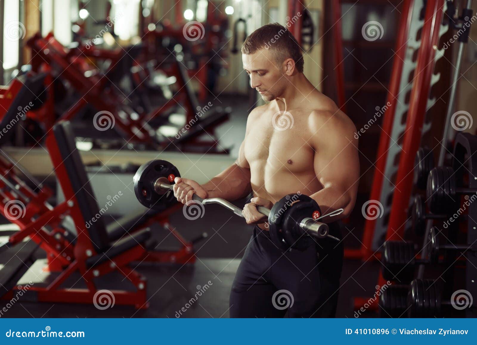 Strong Man Bodybuilder in a Gym Exercising with a Barbell Stock Photo ...