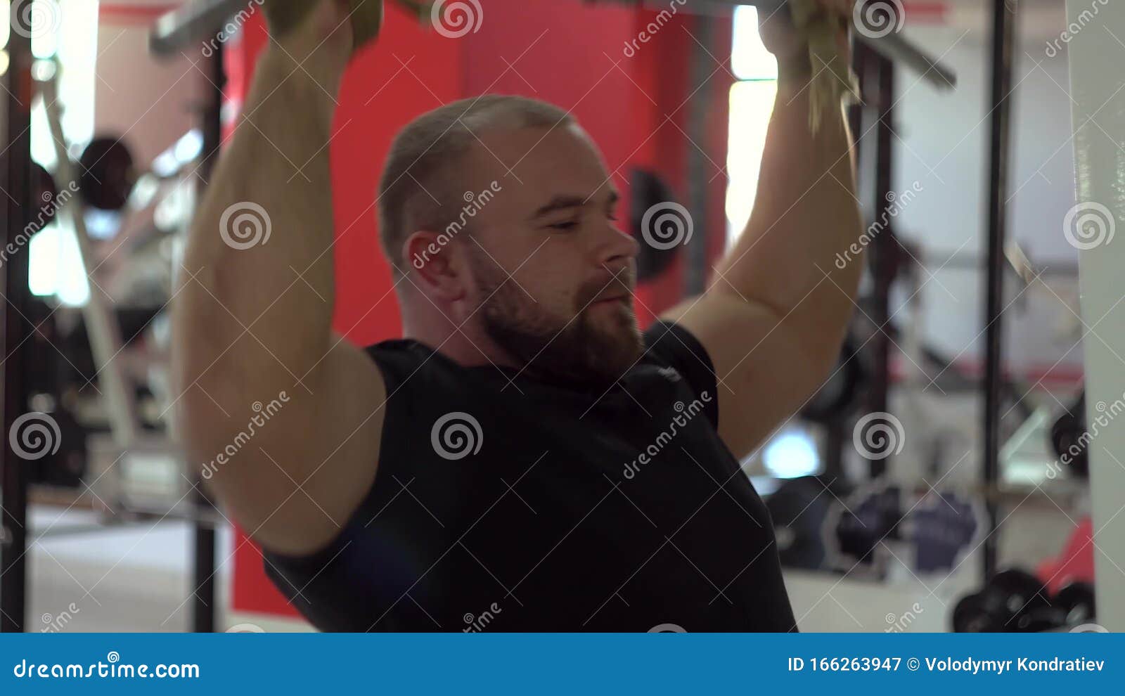 Strong Muscular Man Does Different Kind of Exercises in the Gym Stock ...
