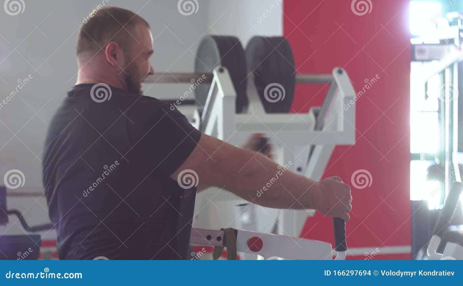 Strong Muscular Man Does Different Kind of Exercises in the Gym Stock ...